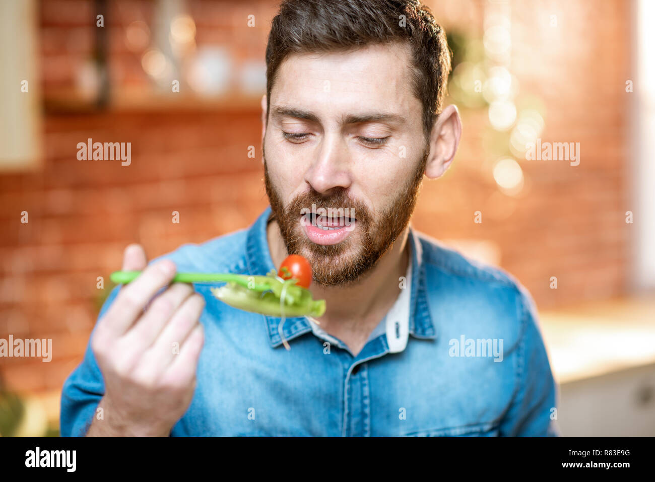 Handsome man eating healthy food hi-res stock photography and images ...