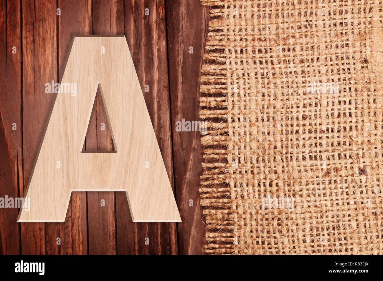 Wooden alphabet letter symbol - A. On wooden table background wih ...