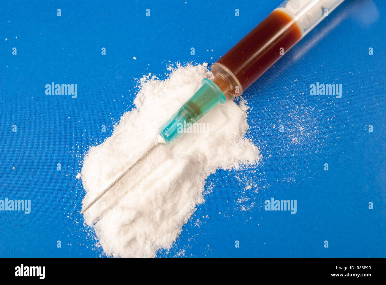 Classic transparent syringe filled with a drug cap and white powder ...