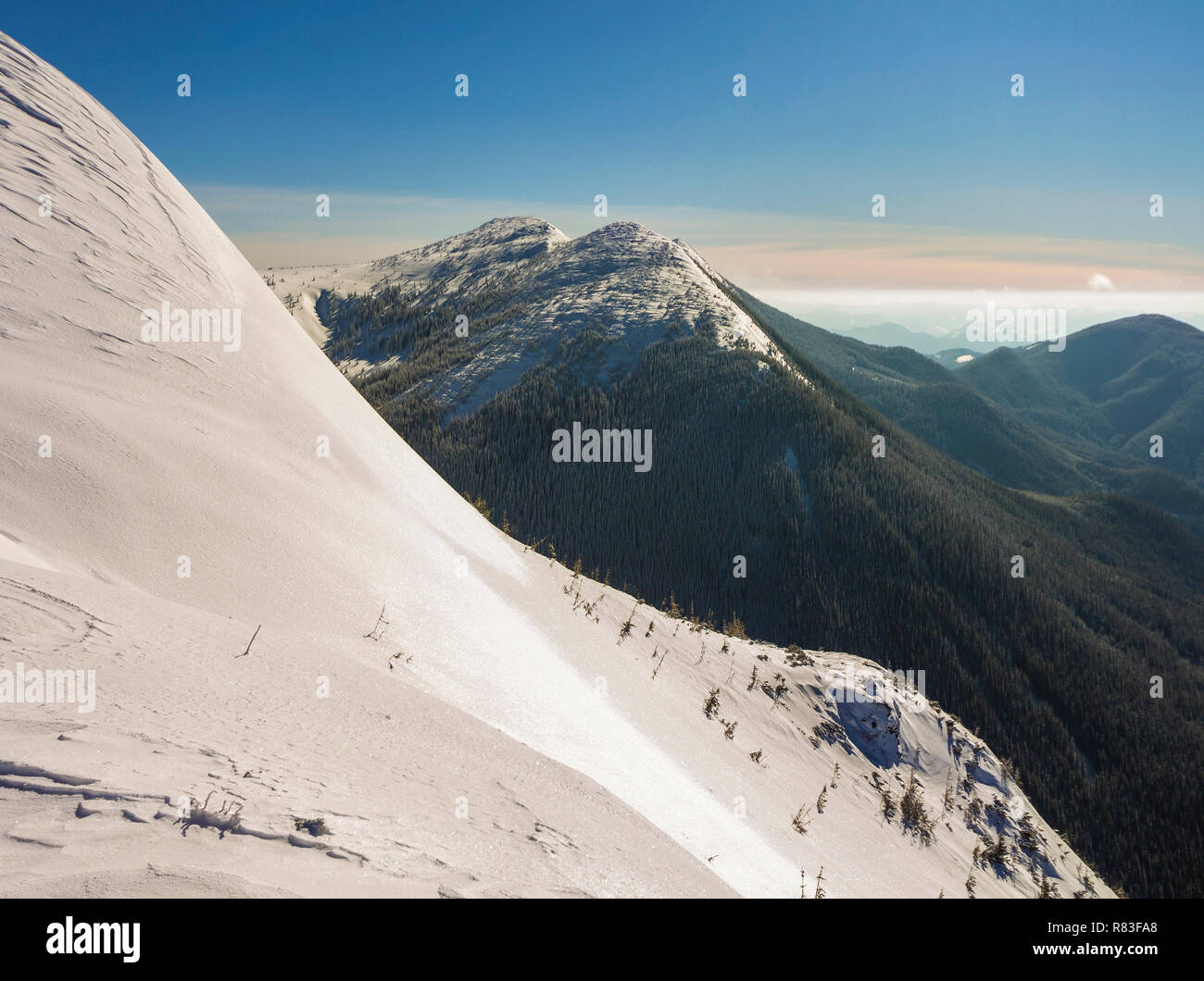 Beautiful winter landscape. Steep mountain hill slope with white deep ...