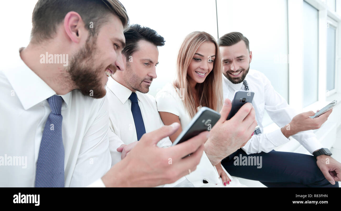 close up.business team using their smartphones Stock Photo - Alamy