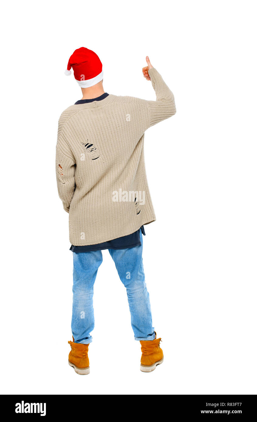 Back view of a man wearing a Santa Claus hat showing his thumb up. Rear ...