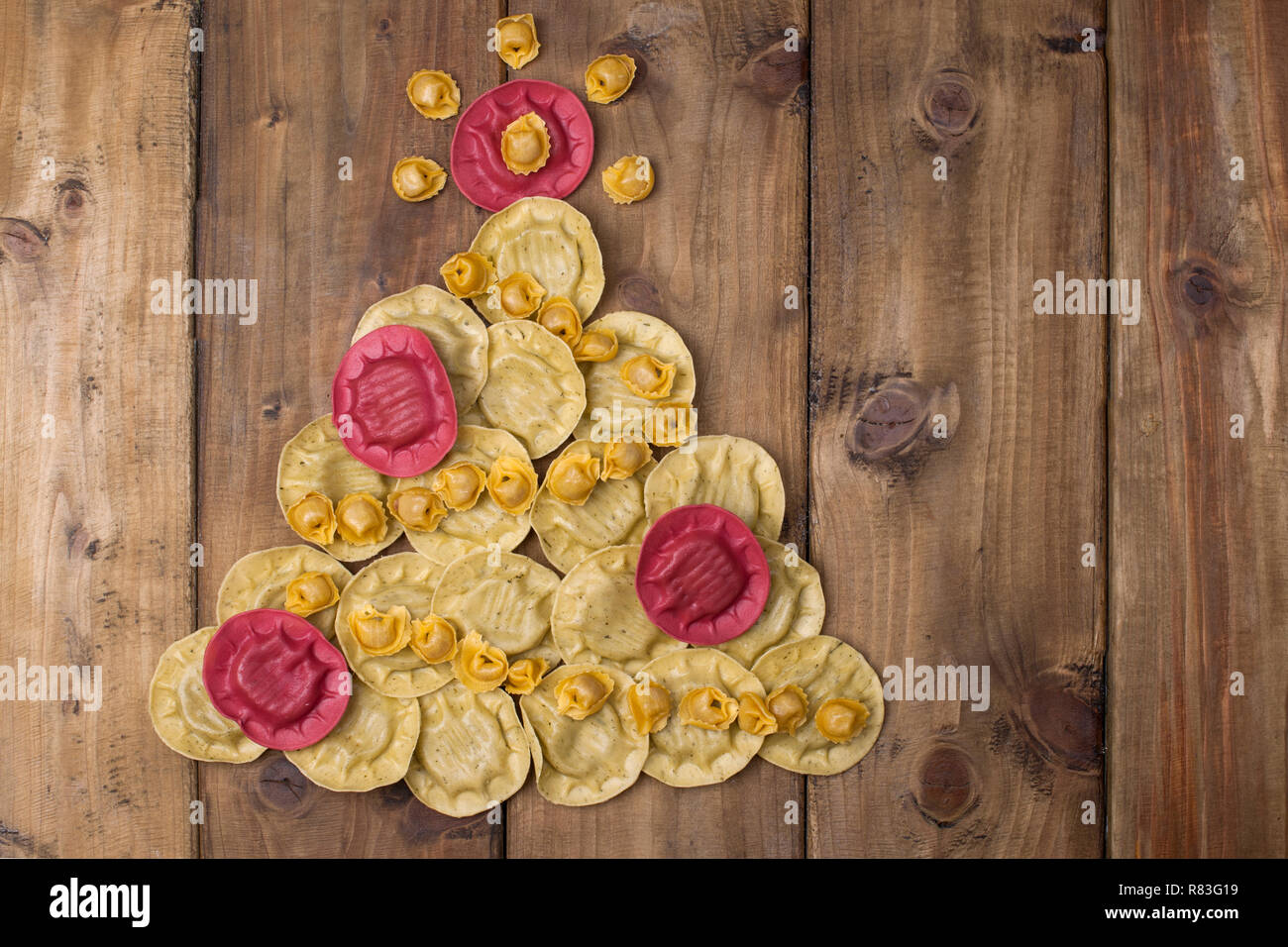 Ravioli like christmas tree on wooden background. Holidays in Italy ...