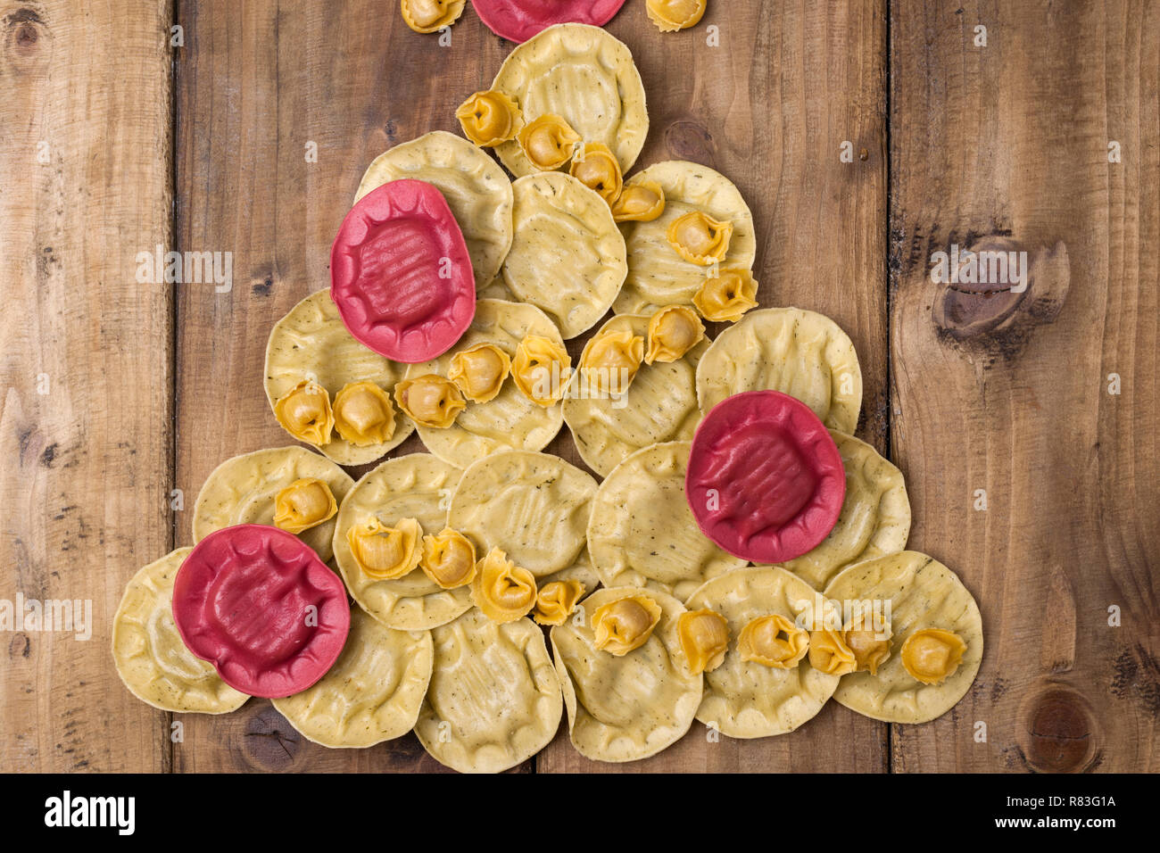 Ravioli like christmas tree on wooden background. Holidays in Italy ...