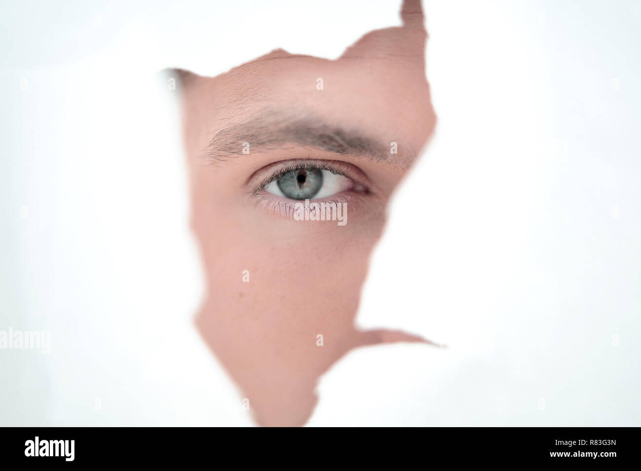 Man looking through hole in wall hi-res stock photography and images ...
