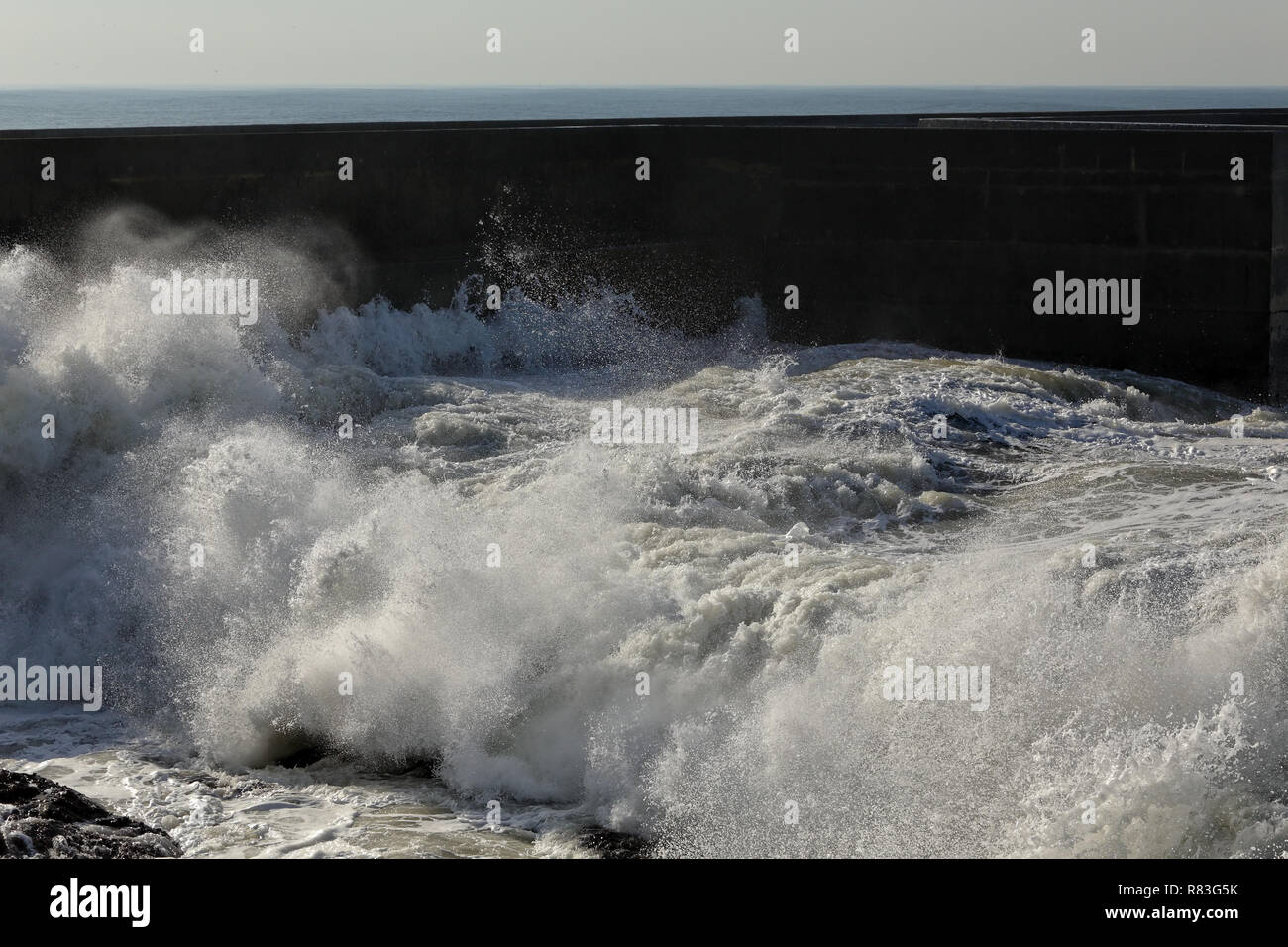 Violent waves breaking along a pier from the north of Portugal Stock ...