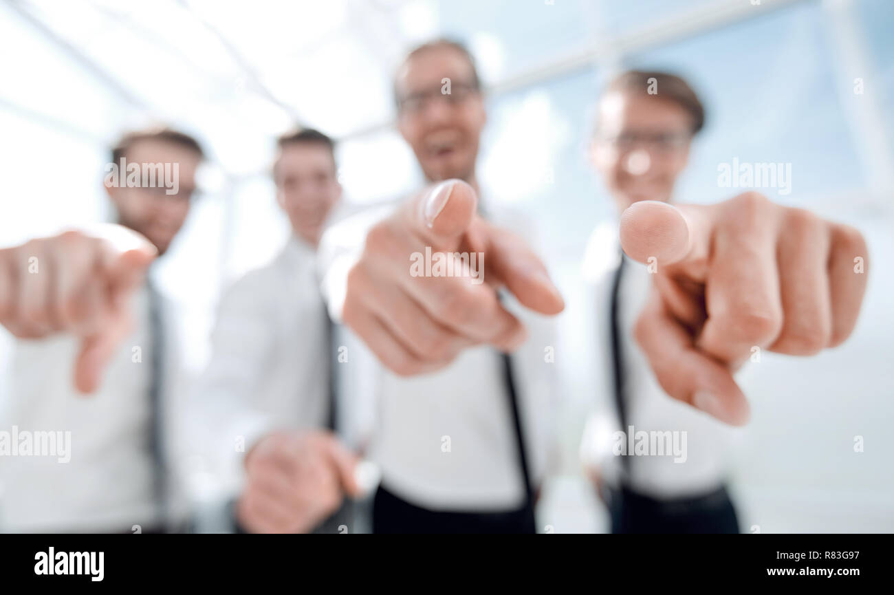business background.happy employees pointing at you Stock Photo - Alamy