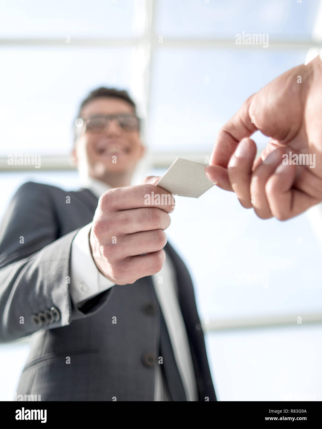 Two businessmen exchanging business card hi-res stock photography and ...