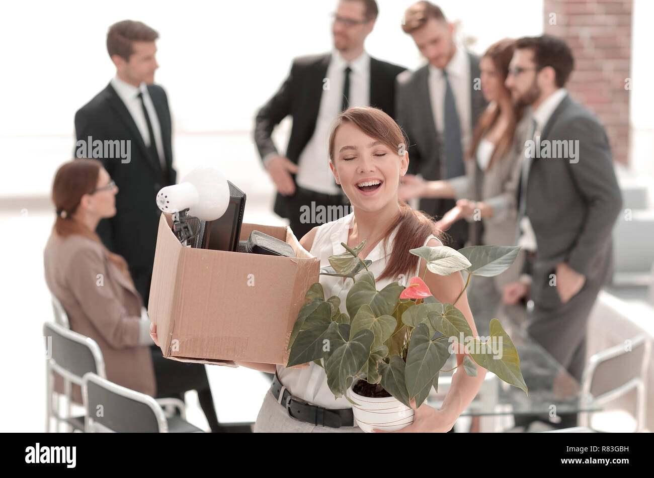 young employee with personal things on the background of the office ...
