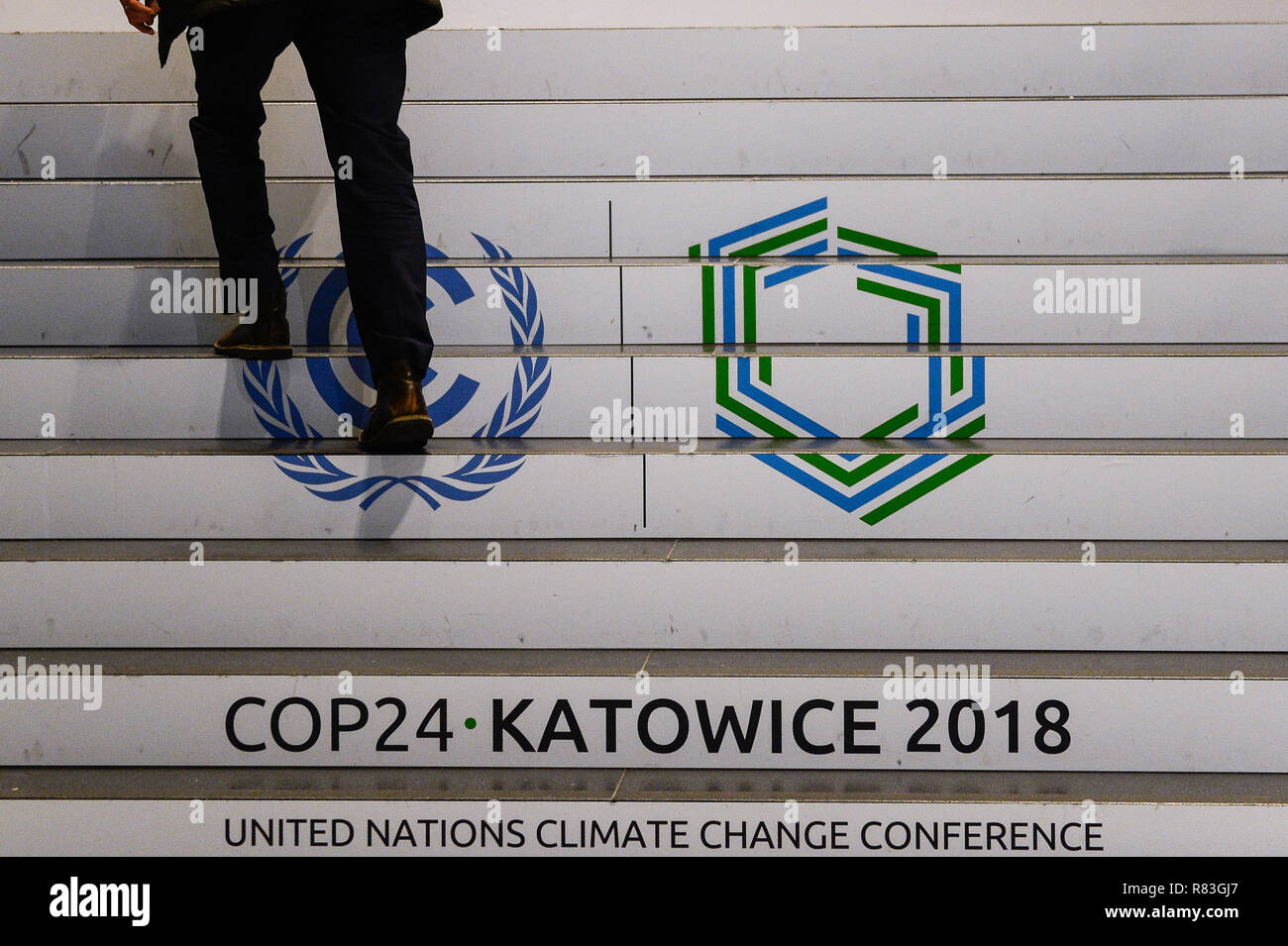 A man is seen walking next to the COP24 sign during the COP24 UN ...