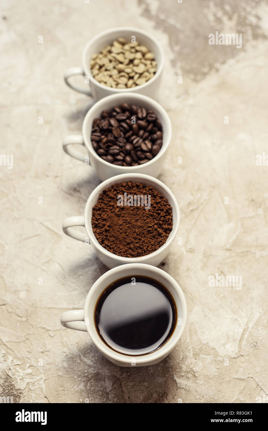 four types of coffee unroasted, bean, ground and one in cup Stock Photo ...