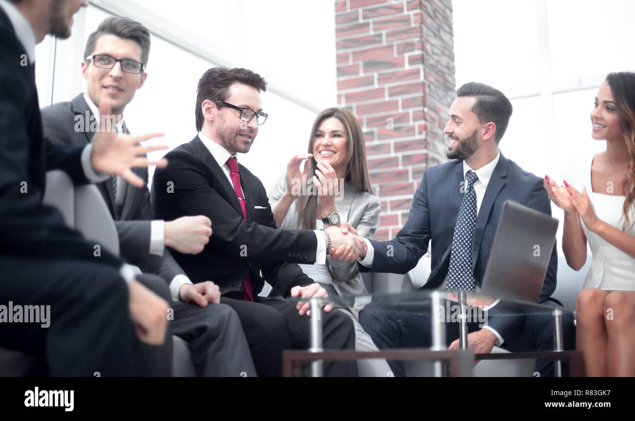 Business colleagues shaking hands couch hi-res stock photography and ...