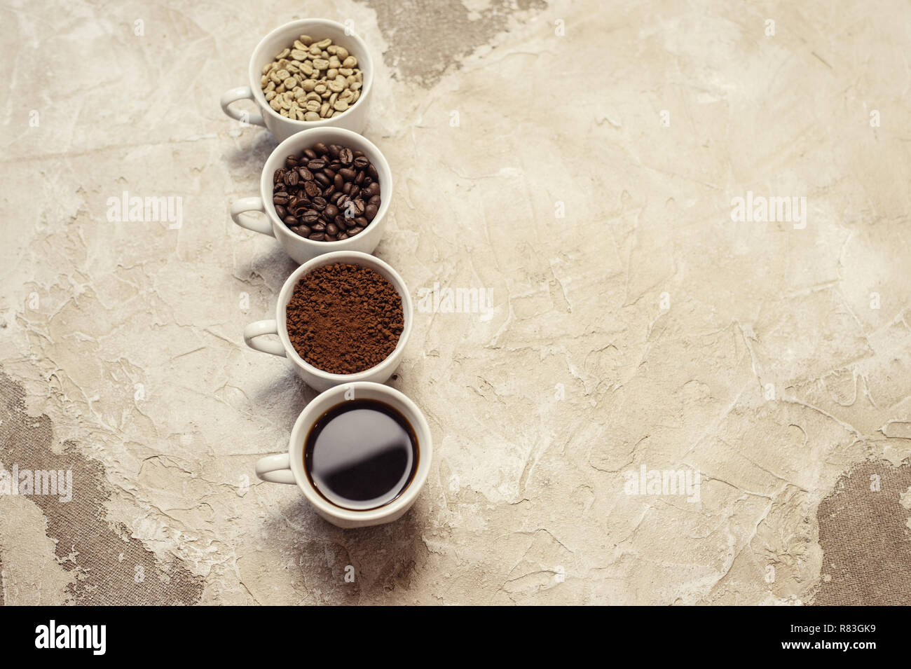 four types of coffee unroasted, bean, ground and one in cup Stock Photo ...