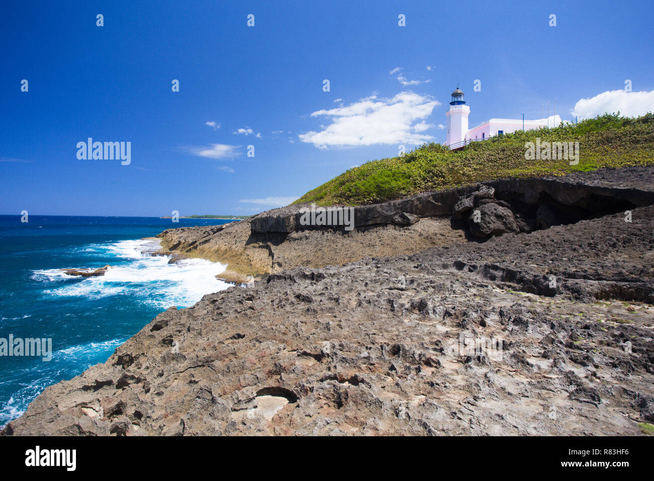 View of Arecibo lighthouse from Puerto Rico coast with rocky shore and ...