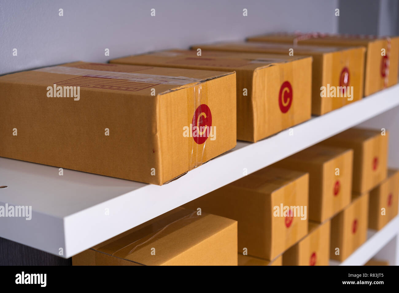 Parcels on shelf ready for shipment to client in the home office Stock ...