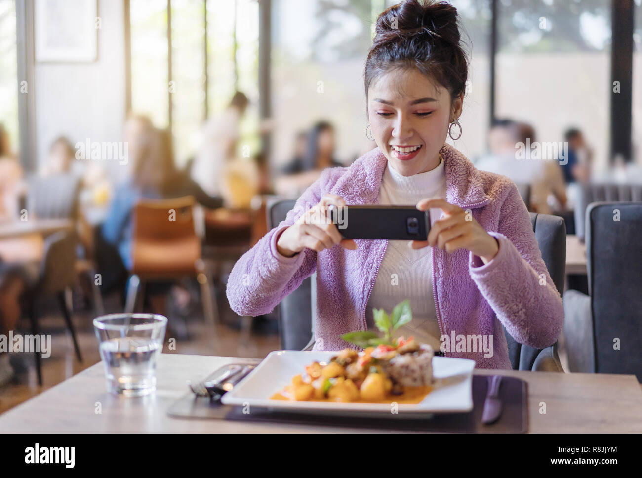 woman using smartphone take photo of food before eating in the ...