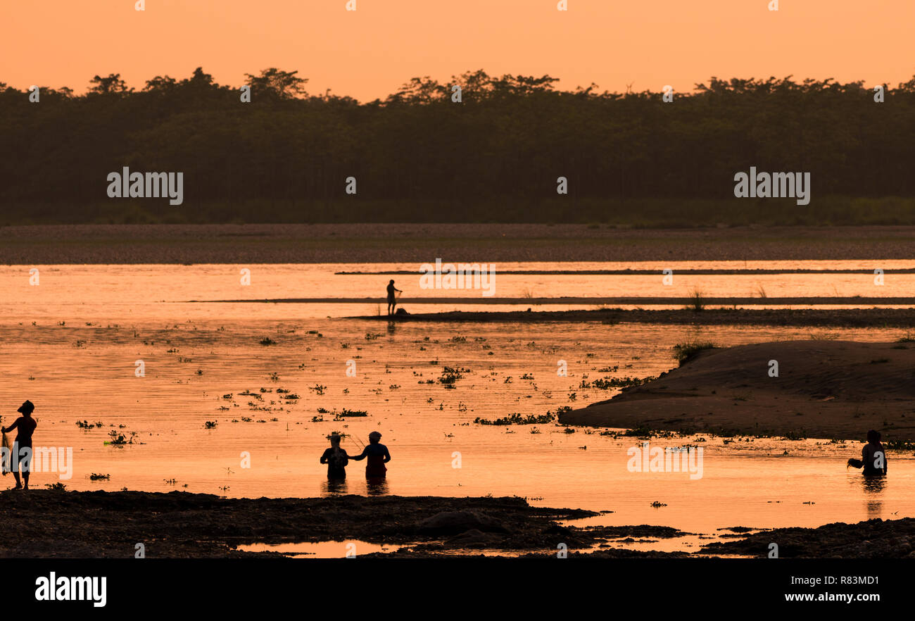 Asian Women fishing in the river. silhouette at sunset. Village life in ...