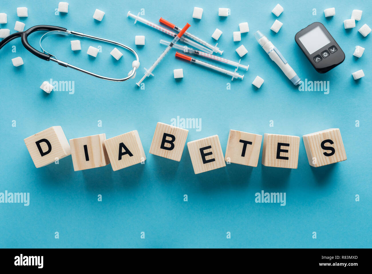 "diabetes" lettering made of wooden cubes with medical equipment on ...