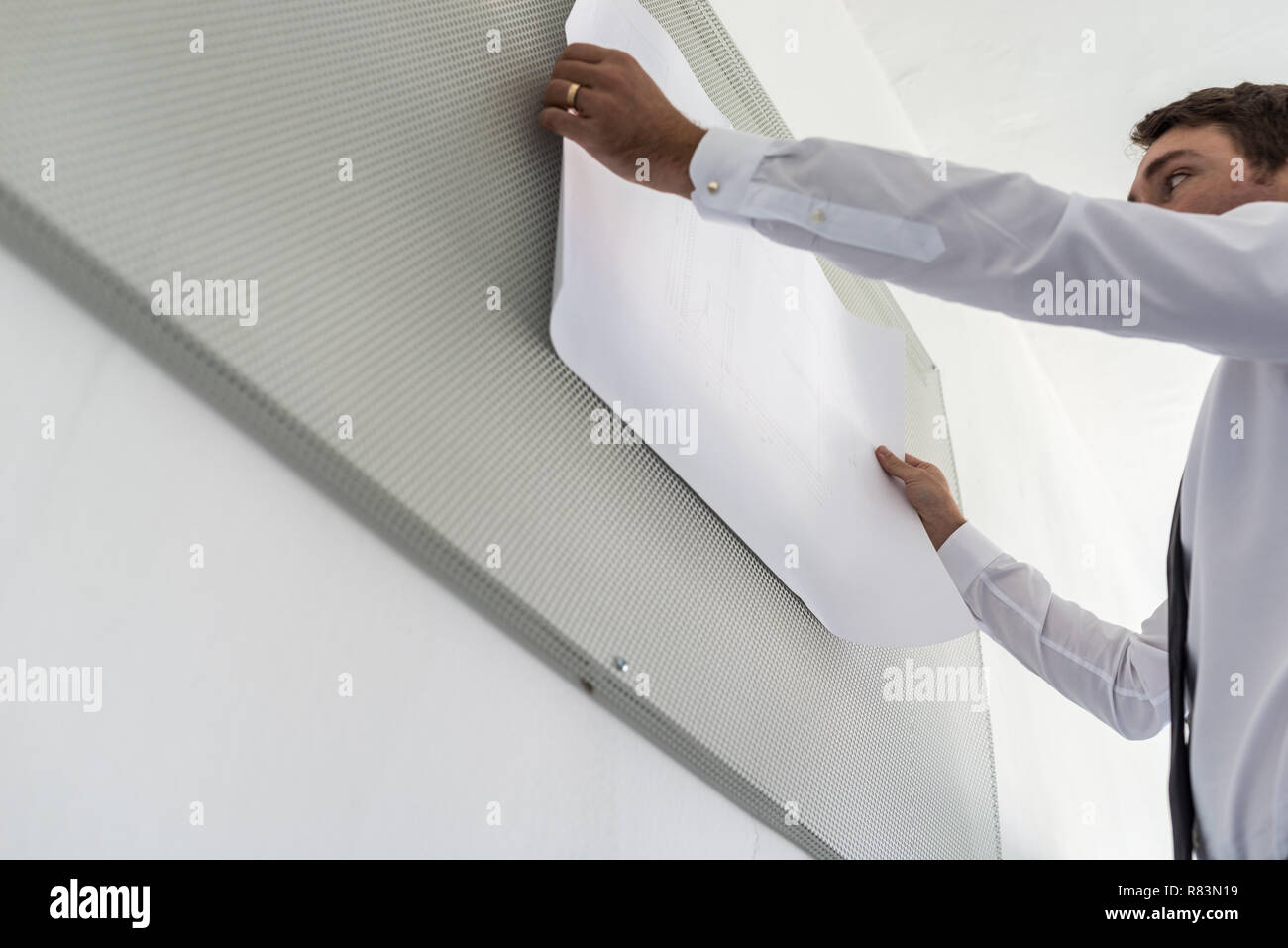 Low angle view of business leader preparing a presentation hanging ...