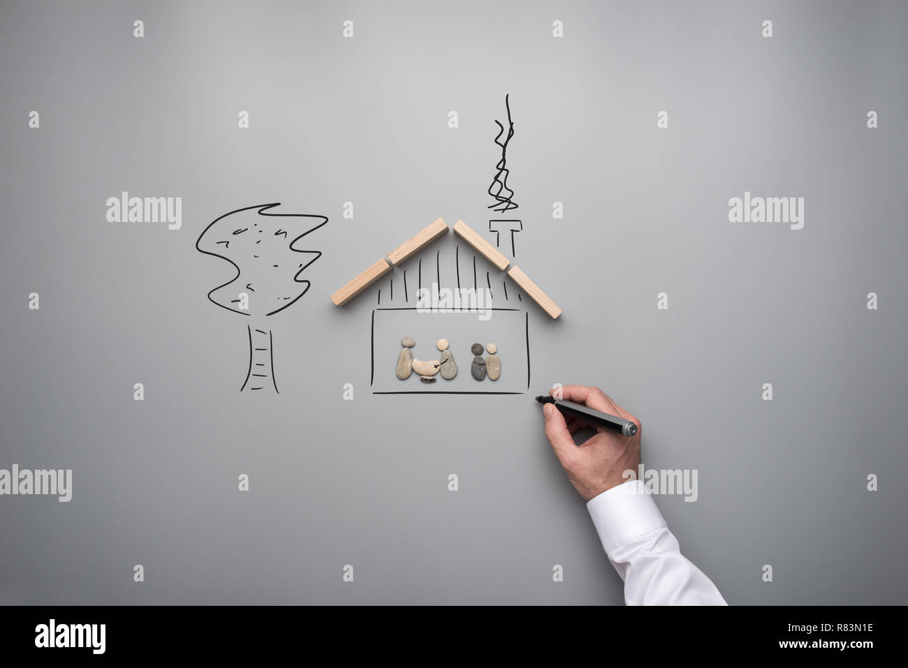 Family happiness concept - male hand drawing a family vision of a house ...