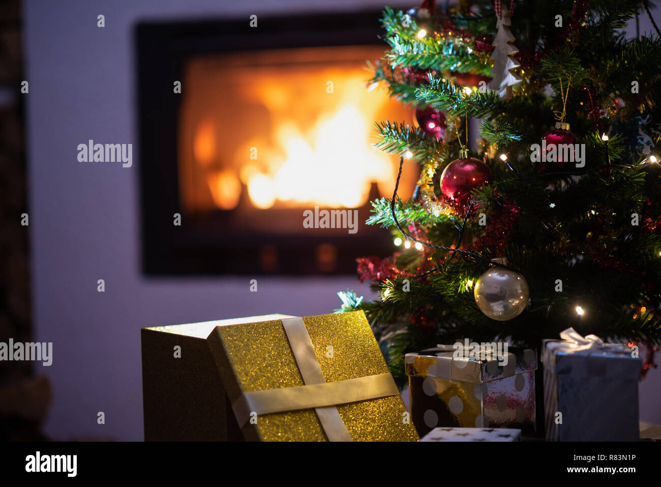 Christmas holiday season scene - open golden gift box under holiday ...