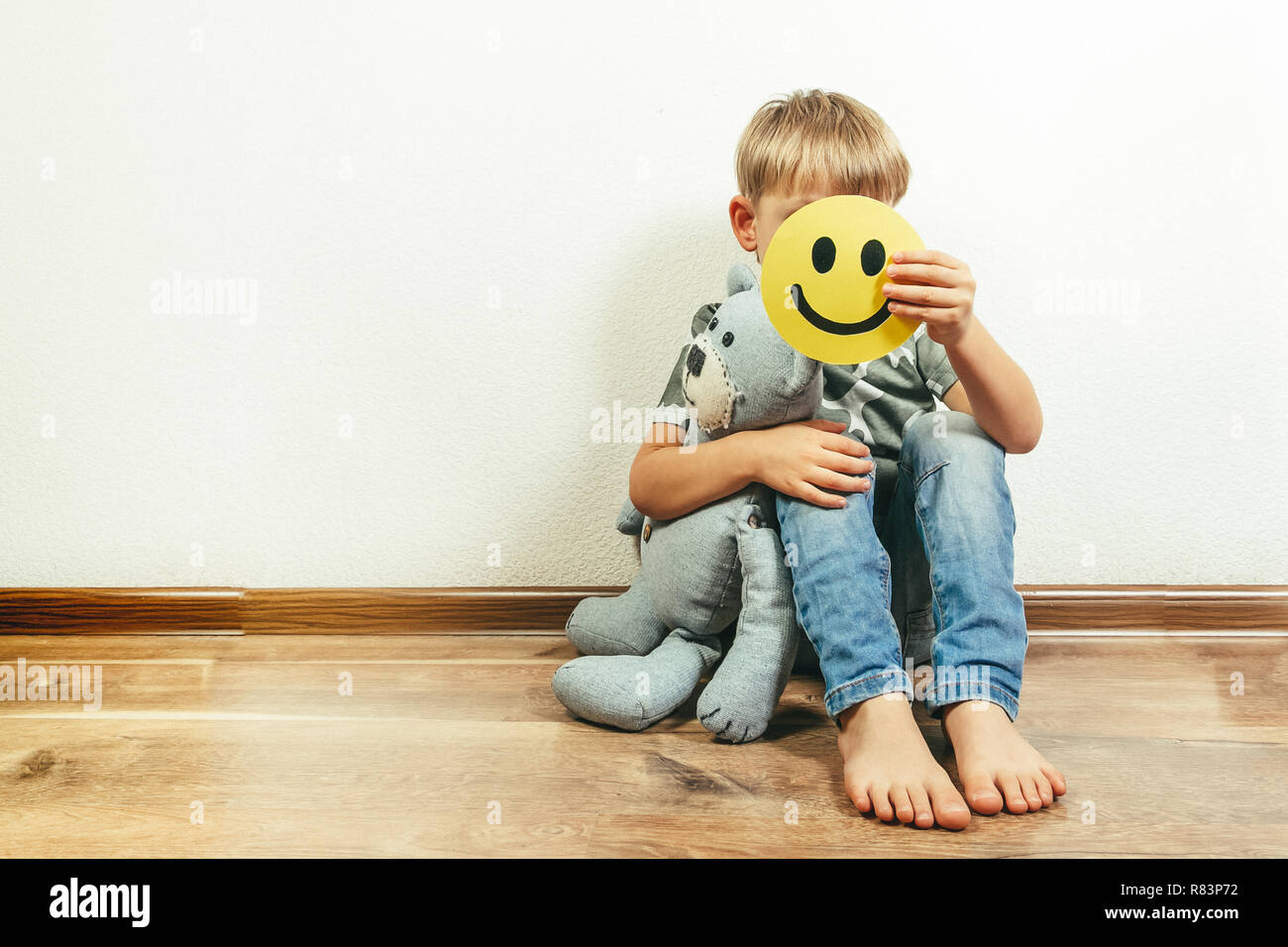 Depressed boy holding smile, pretending to be fine. Face of the ...