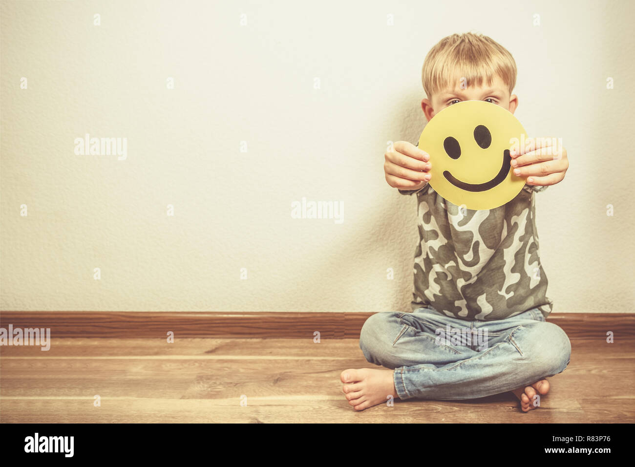 Depressed boy holding smile, pretending to be fine. Face of the ...