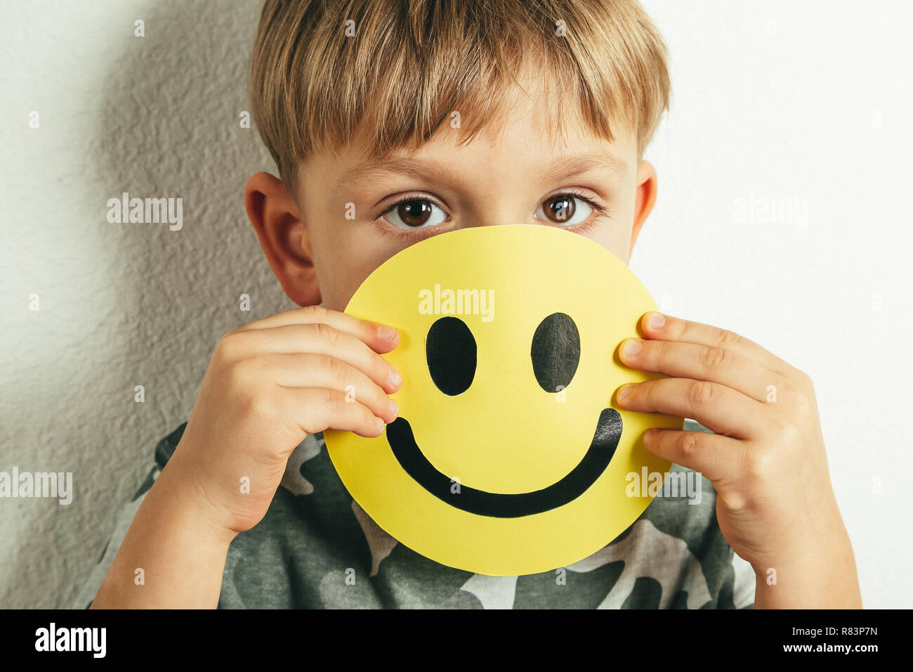 Depressed boy holding smile, pretending to be fine. Face of the ...