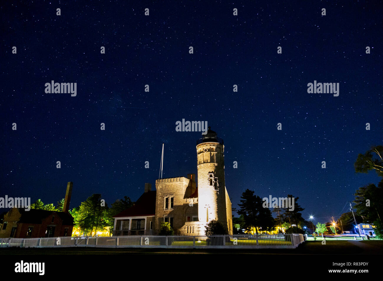 Historic Old Mackinac Point Lighthouse at night. This lighthouse, now a ...
