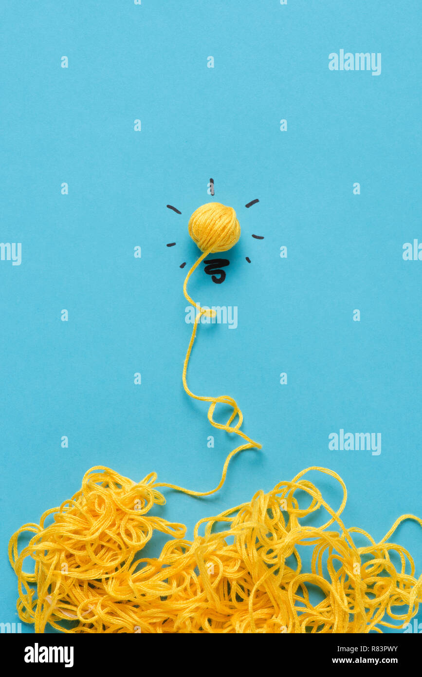 light bulb sign made of yellow yarn on blue background, ideas concept ...
