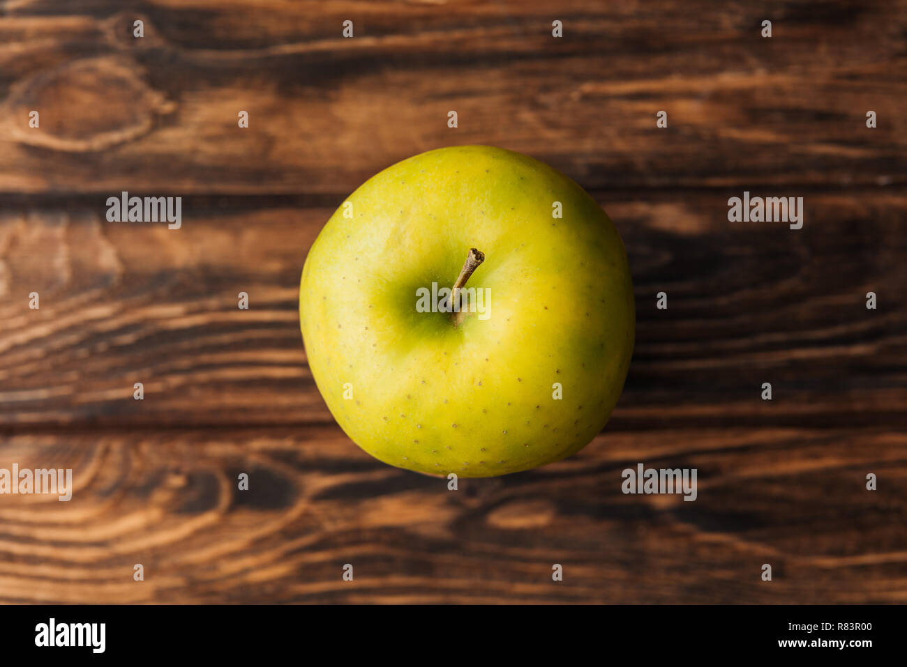 top view of ripe golden delicious apple on wooden table Stock Photo - Alamy
