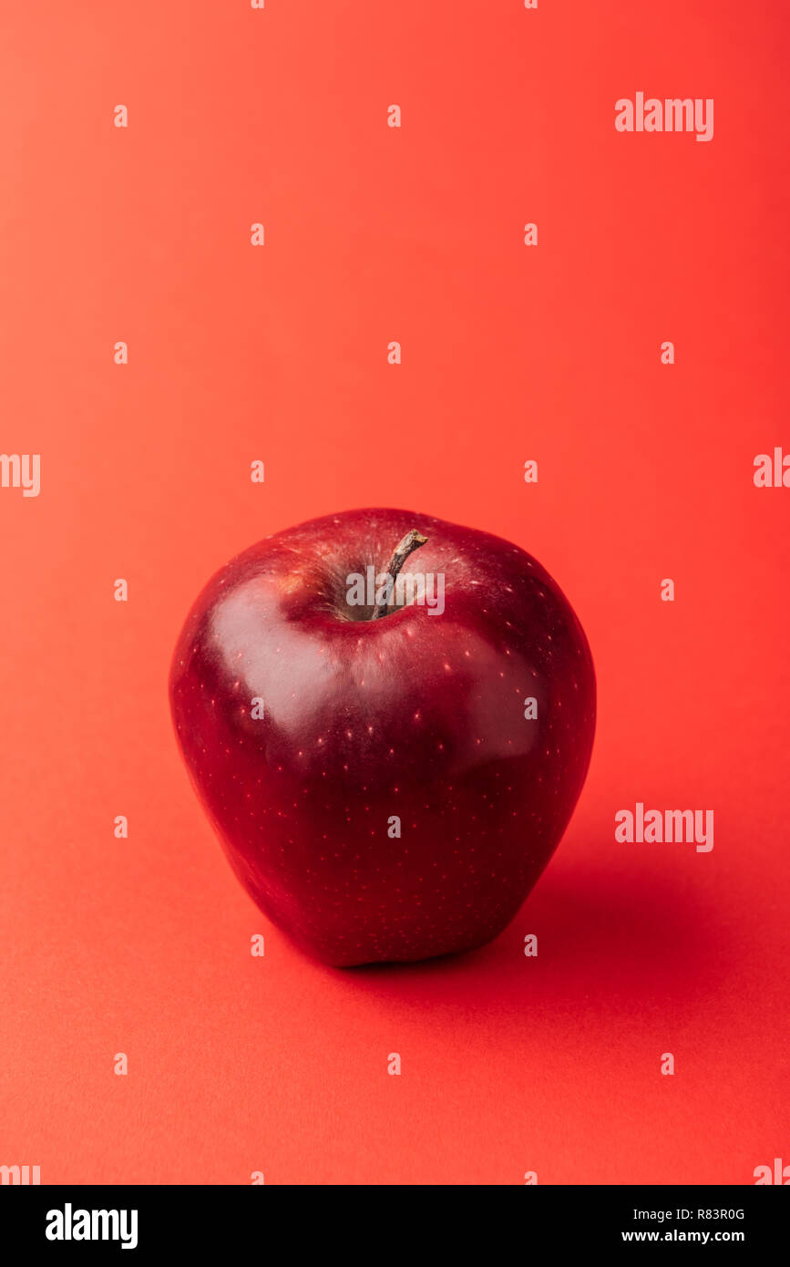 delicious large apple on red background Stock Photo - Alamy