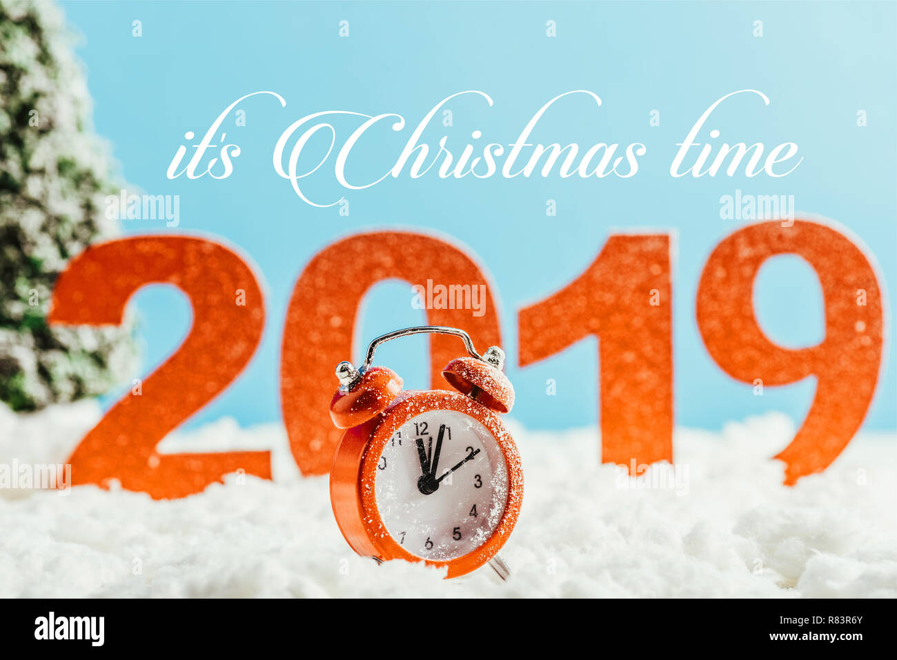 big red 2019 numbers with vintage alarm clock standing on snow on blue ...