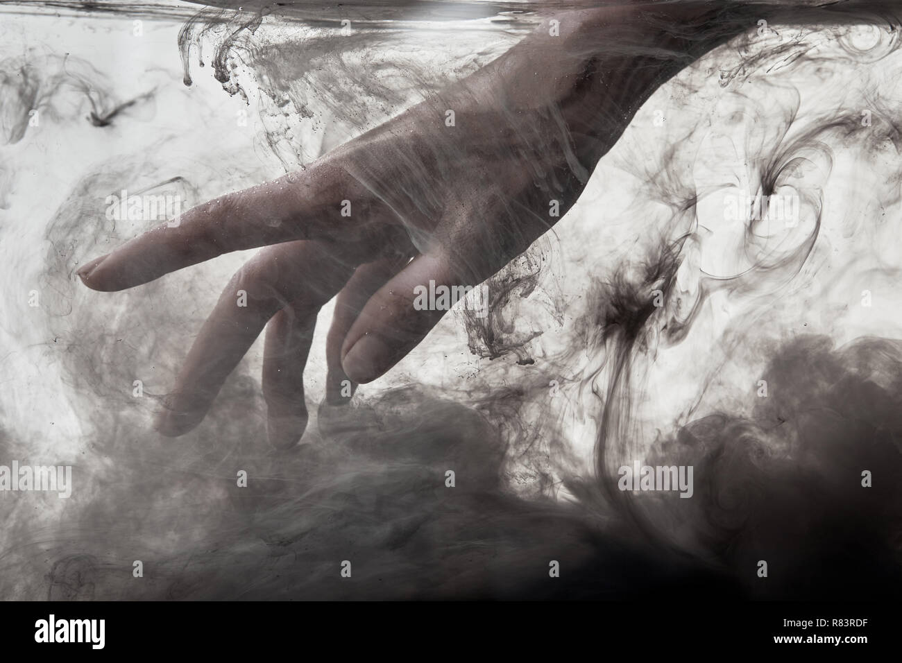 female hand in water with grey paint Stock Photo - Alamy