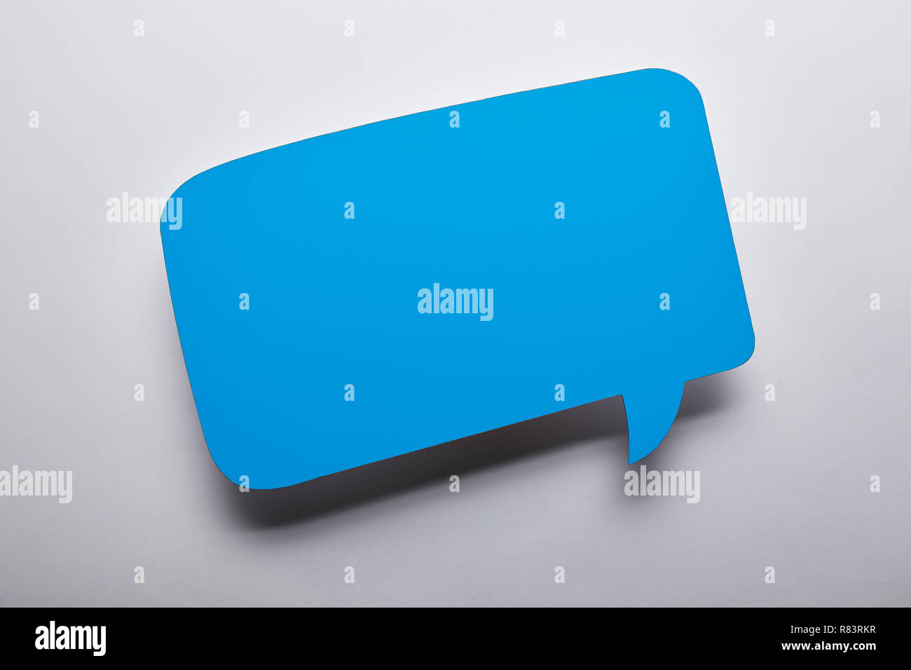 top view of empty blue speech bubble on grey background Stock Photo - Alamy