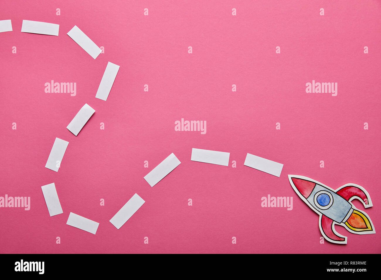 top view of rocket with direction on pink background Stock Photo - Alamy