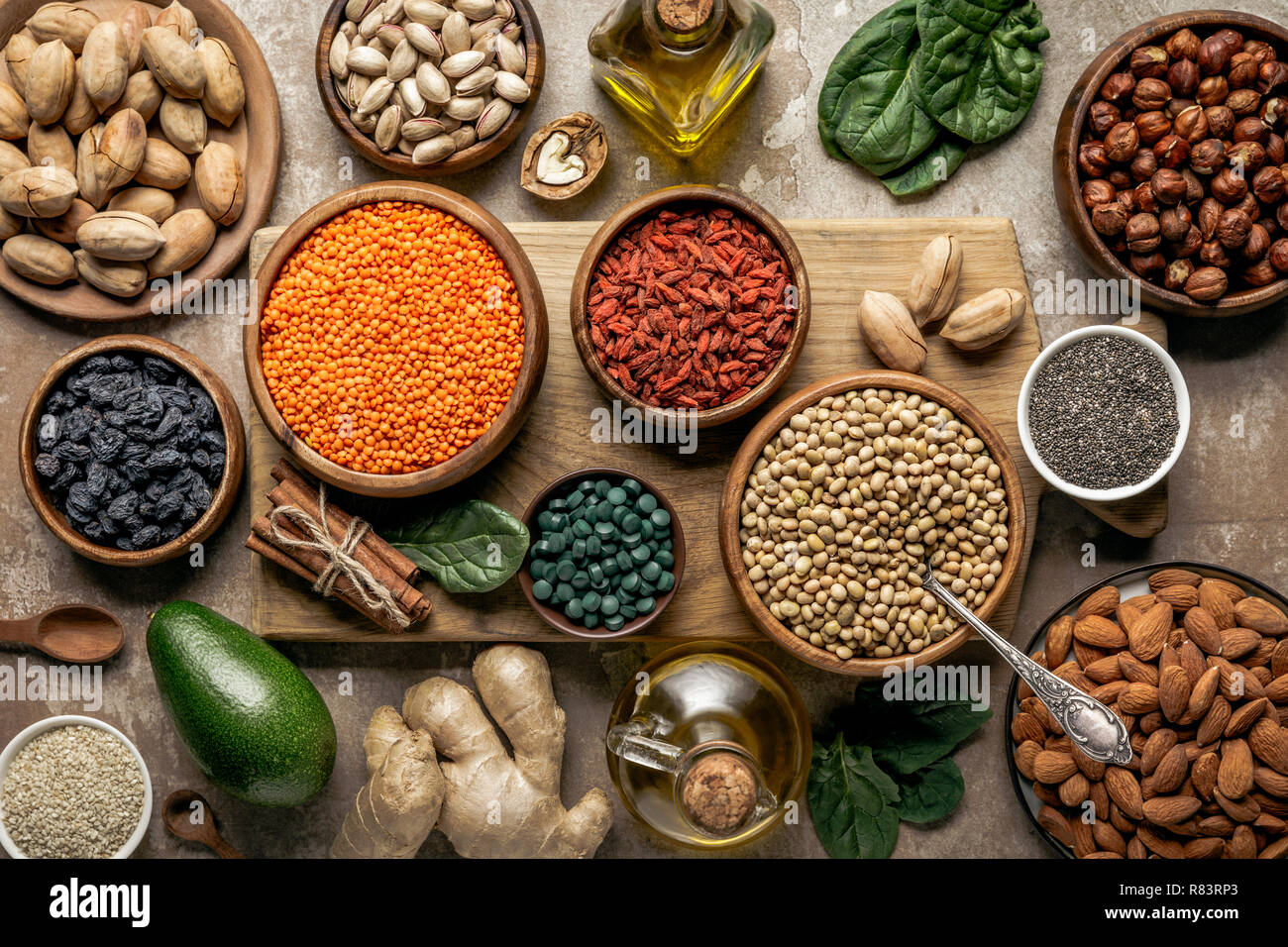 flat lay of legumes, superfoods and healthy ingredients on wooden board ...