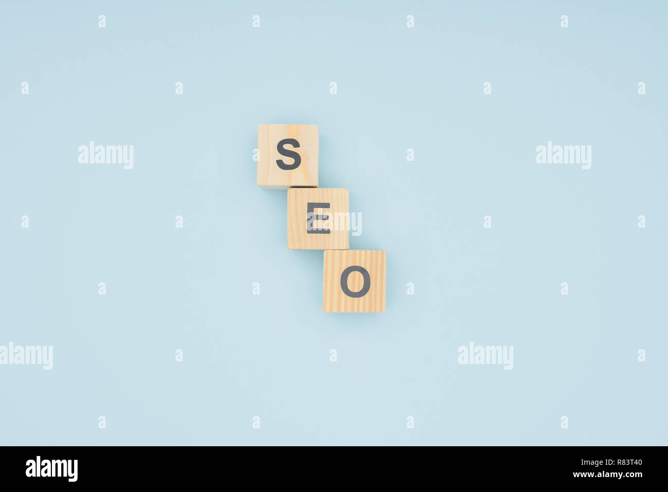 Flat lay of wooden blocks on light blue background Stock Photo - Alamy