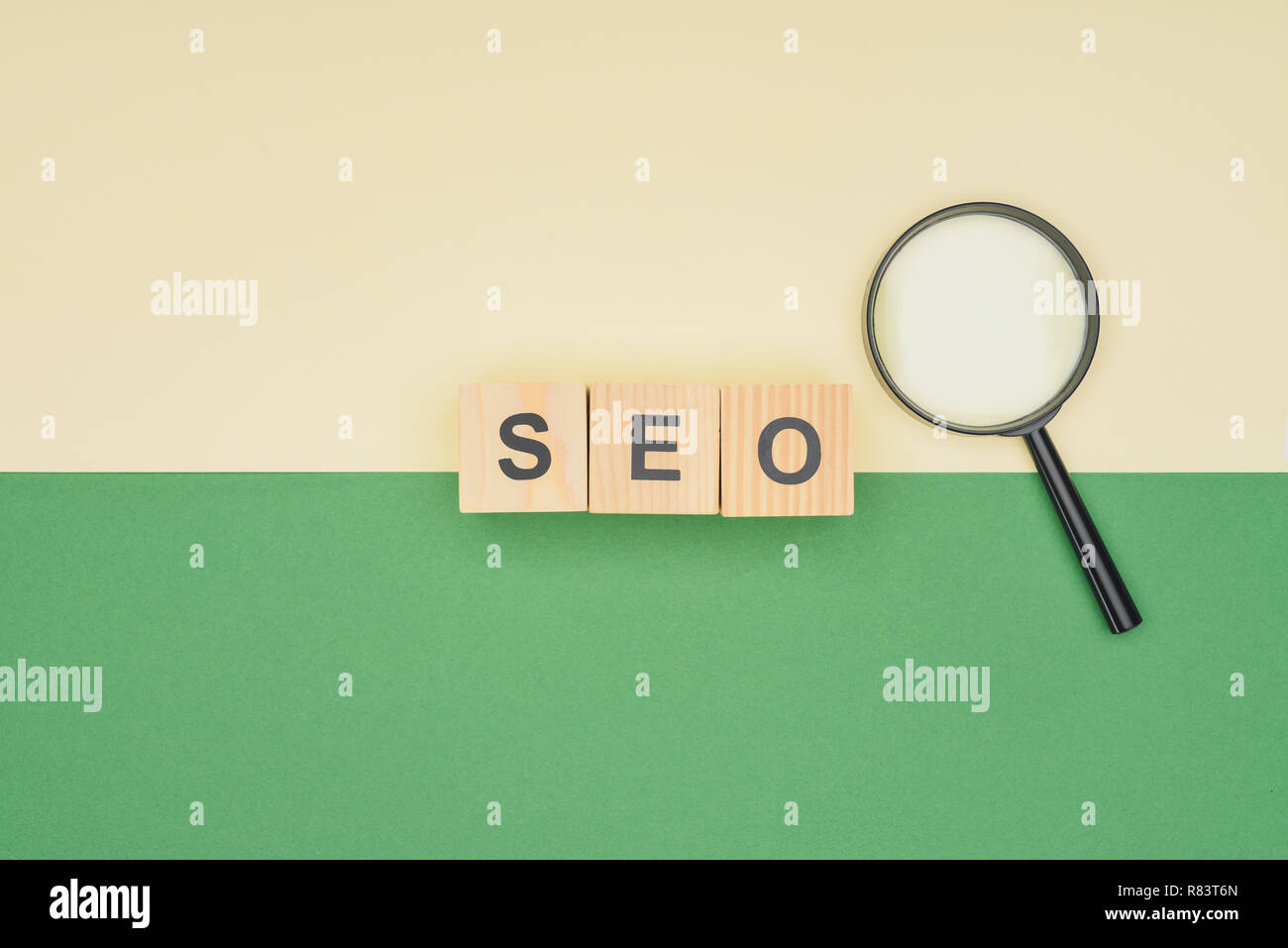 Flat lay of wooden blocks and magnifier glass Stock Photo - Alamy