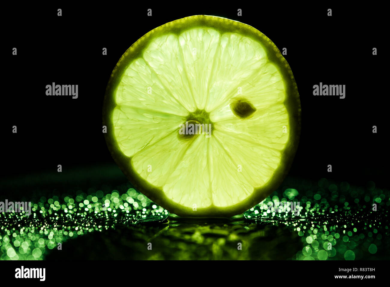 slice of neon lime on black background with backlit Stock Photo - Alamy