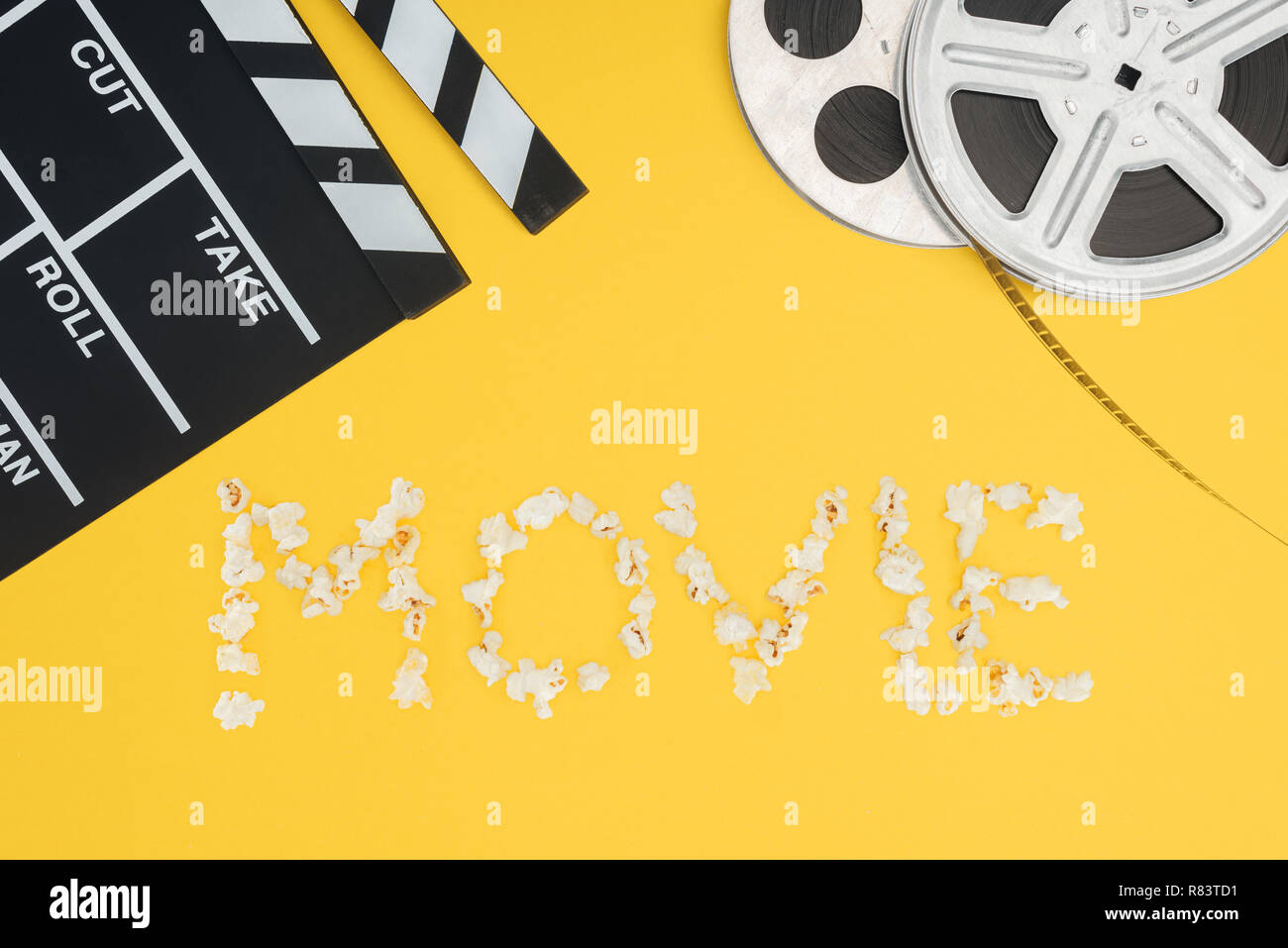 clapperboard, film reels and "movie" lettering made with popcorn ...
