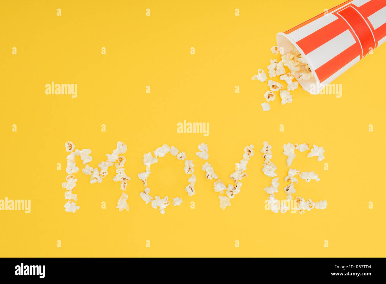 overturned bucket with popcorn and "movie" lettering made with popcorn ...