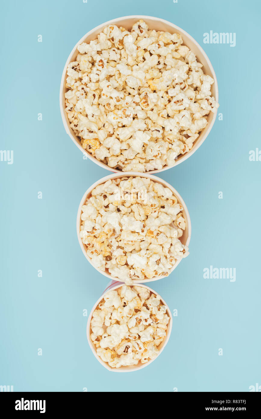 top view of popcorn buckets of different sizes in vertical row isolated ...