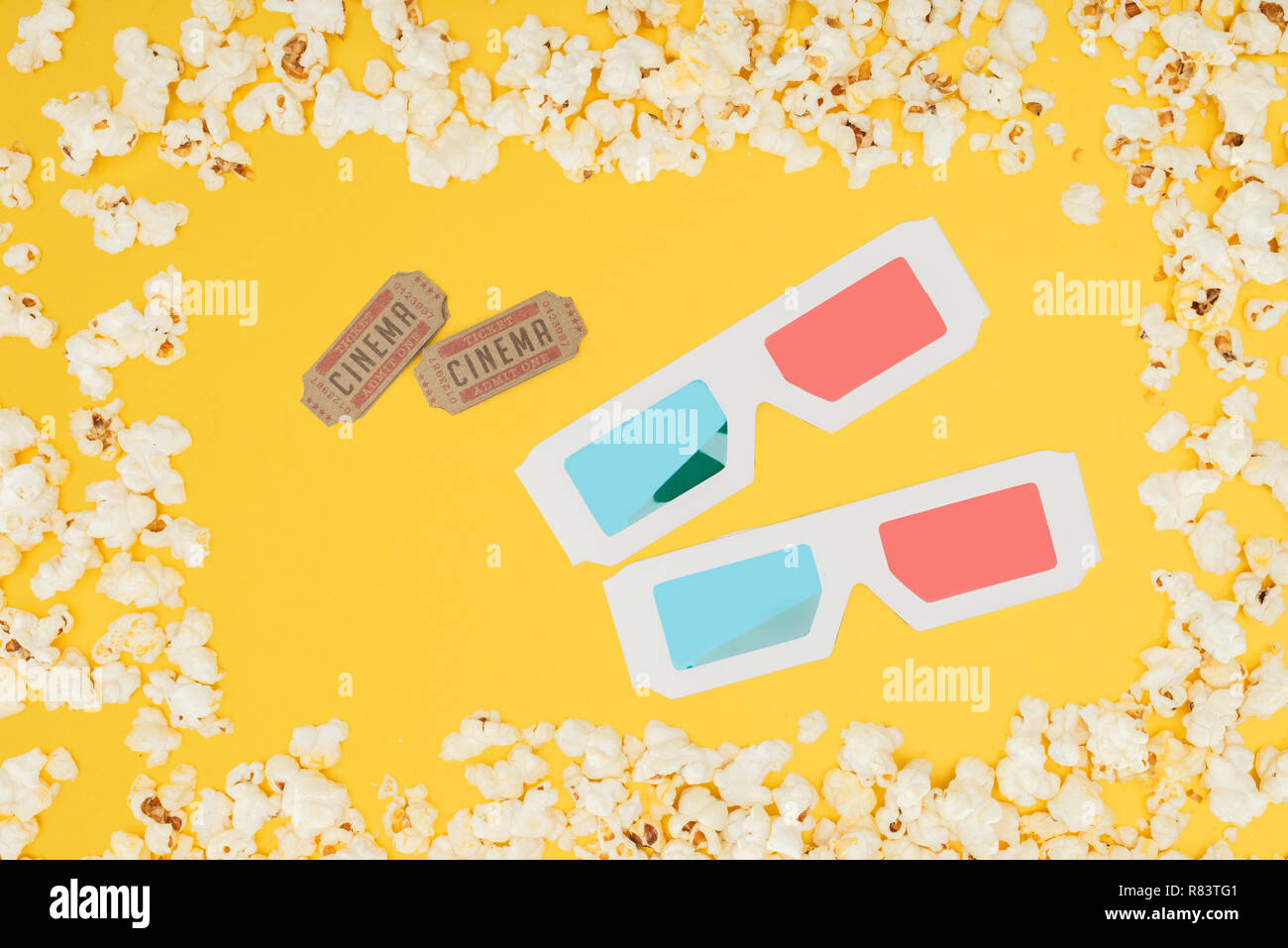 cinema tickets and 3d glasses in frame made of tasty popcorn isolated ...