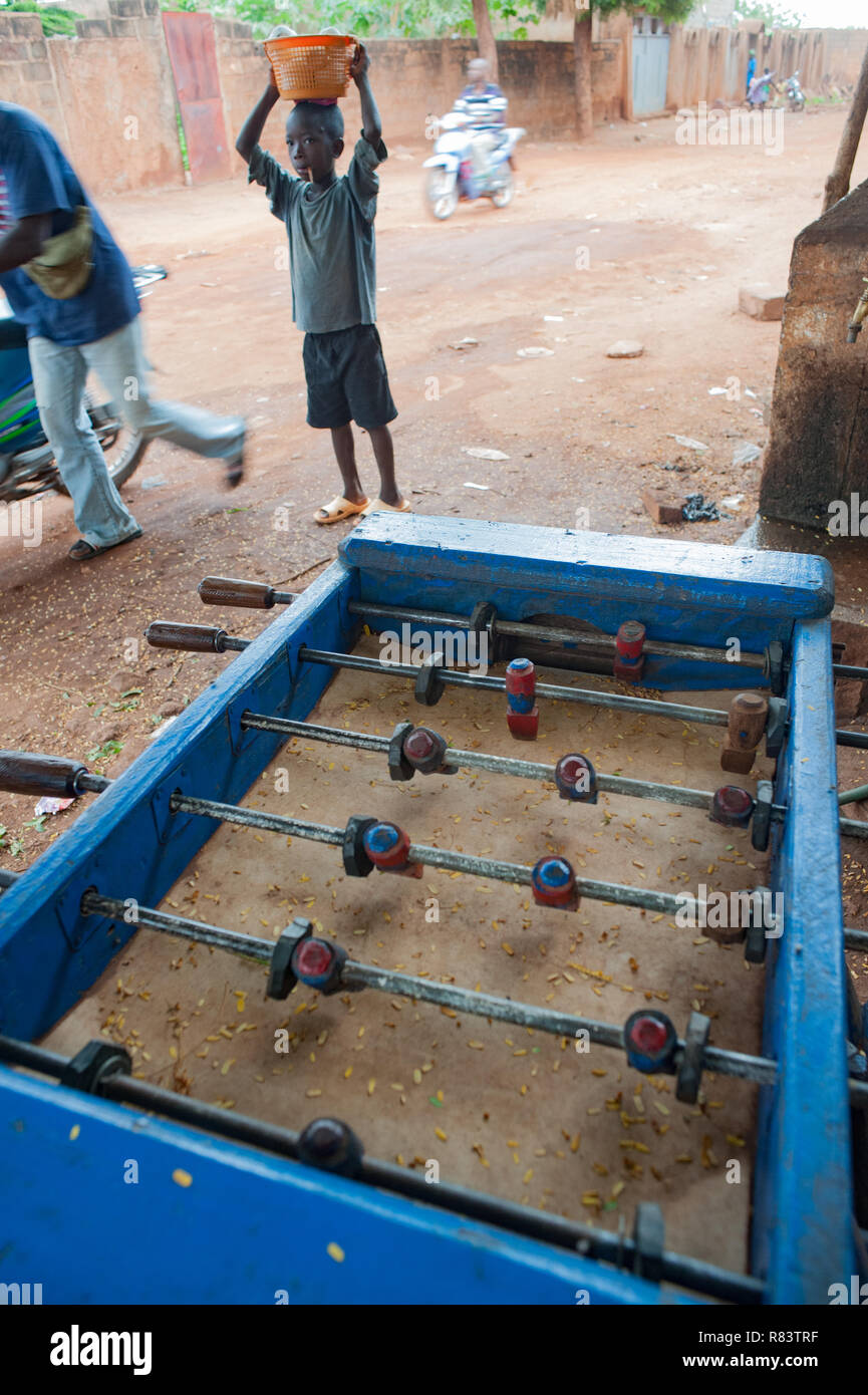 Mali, Africa - Black young boy carrying food on his head. Bamako town ...