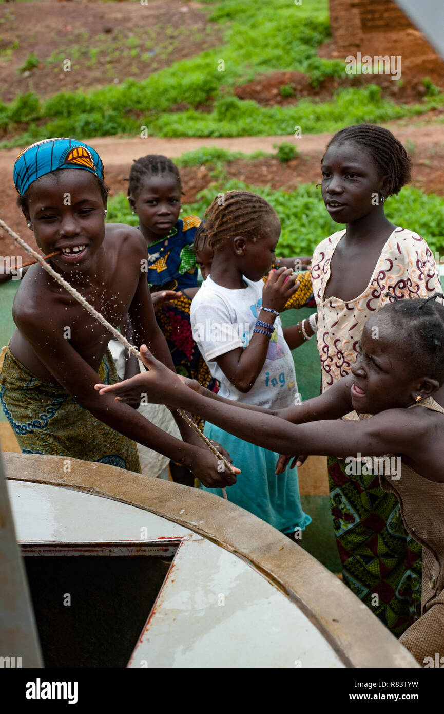 Mali, Africa . Black young girls having fun working and playing on a ...