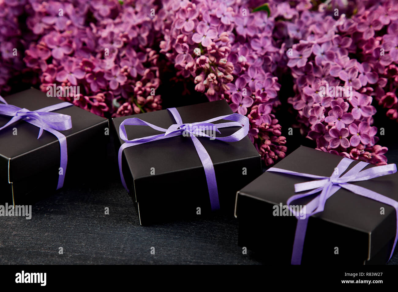 Black small gift boxes wrapped with violet , purple ribbon decorated ...