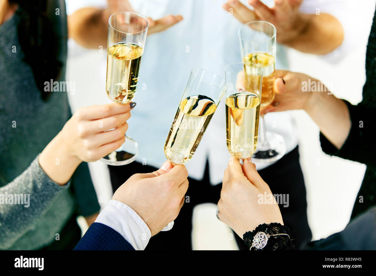 Celebration. Hands holding the glasses of champagne and wine making a ...
