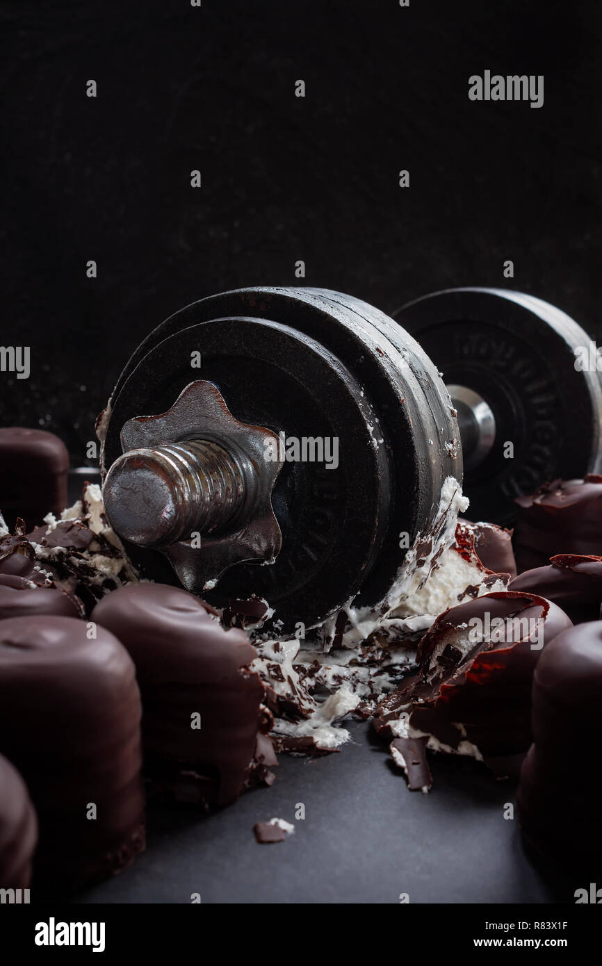 Iron dumbbell dropped in the middle of chocolate covered marshmallows ...