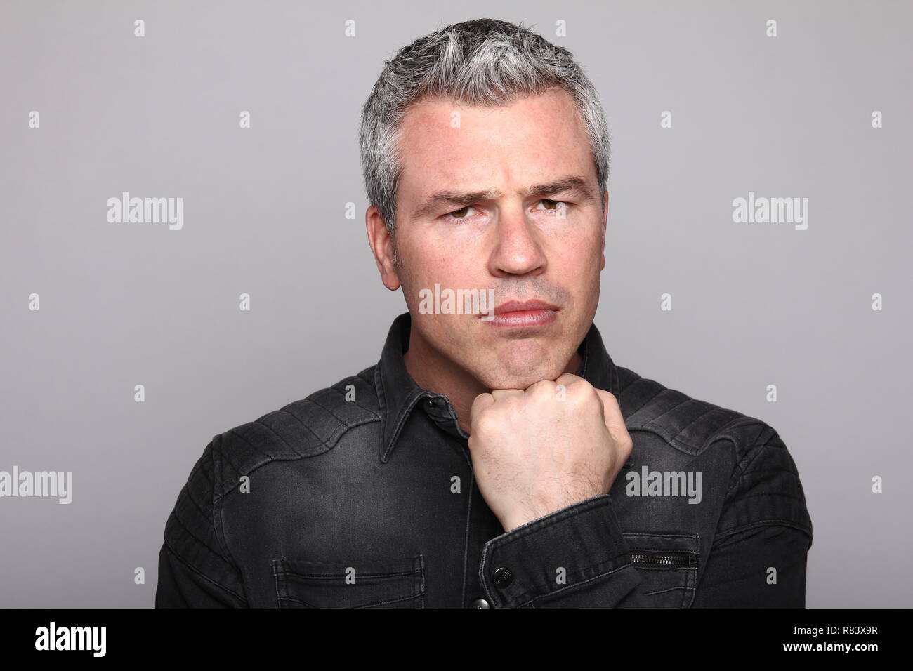 Portrait of a beautiful Caucasian man in front of a white background ...
